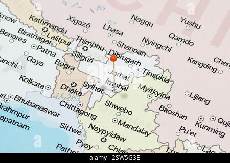 Close up to a Imphal city with an orange pin needle into India country ...