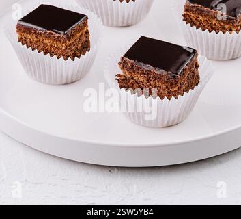 Chocolate-glazed mini cakes Stock Photo - Alamy