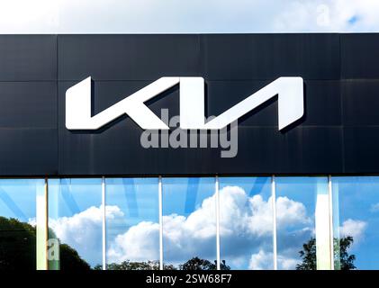Korean automaker brand KIA. KIA logo on the wall of the office building ...