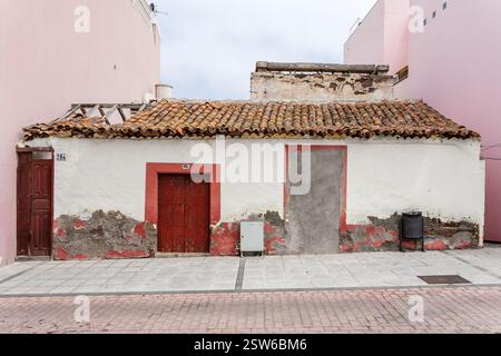 An old weathered building facade surrounded by greenery Stock Photo - Alamy