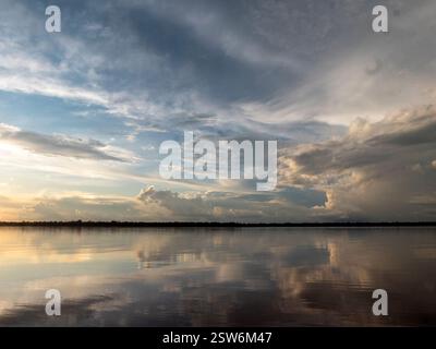 Amazon river landscape. Clouds are reflected on the huge expanse of ...