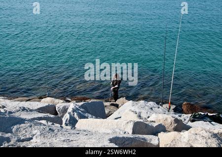 Fishing with rod in the breakwater, Picordia beach, Arenys de Mar ...
