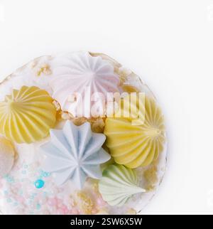 Colorful meringue topped cake on white background Stock Photo - Alamy