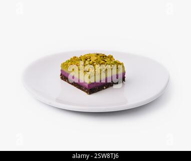 Pistachio cake on a white plate on wooden surface Stock Photo - Alamy