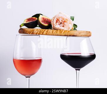 two glasses with rose wine and pink peony bouquet. delicious refreshing ...