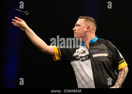 Chris Dobey in action against Michael Smith (not pictured) on day five ...