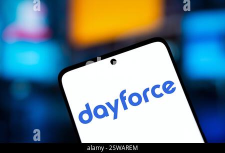Dayforce logo is displayed on smartphone. Dayforce Inc provides HR ...