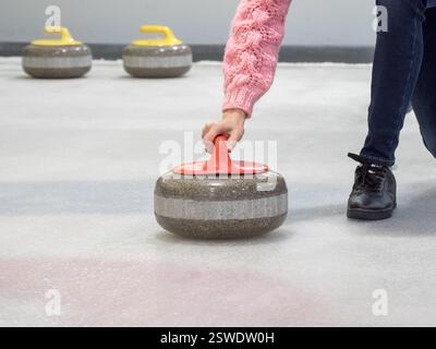 Curling training on the ice rink - leading granite stone on the ice and ...