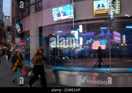 People walk past the Nasdaq MarketSite Times Square event space in ...
