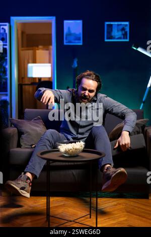 Livid supporter watching sports match on live television broadcast ...