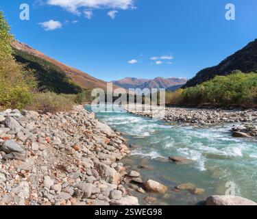 Flow, for a stormy river among the rocks in the autumn park on a warm ...