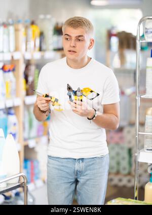 Supermarket shopping - man selects various nuts in produce section ...