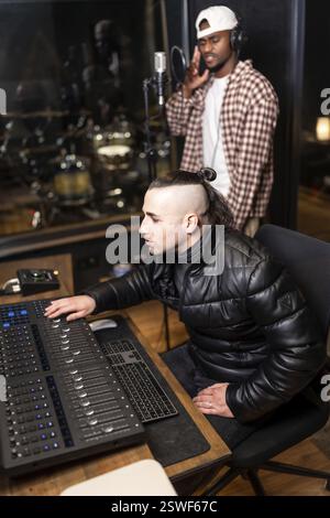 Audio engineer recording new music working inside production studio ...