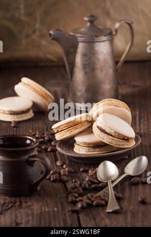 Homemade macaroons on ceramic plate with silver spoon, old silver ...