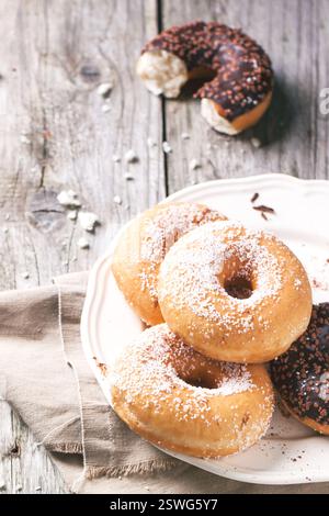 A glazed round pastry with red crumb topping and white drizzle sits on ...