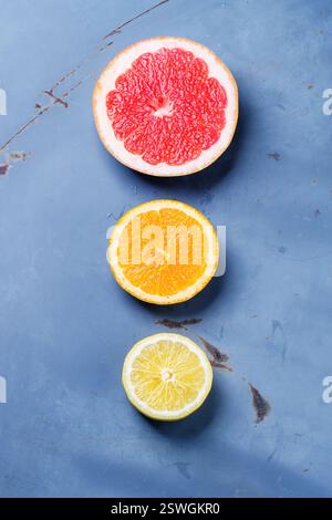 Sliced citrus on blue background. Orange, lemon and lime Stock Photo ...