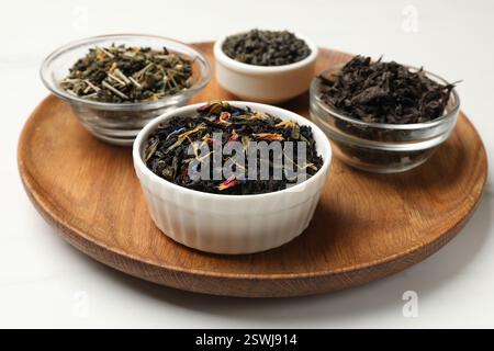 Bowls with dry tea leaves on dark table Stock Photo - Alamy