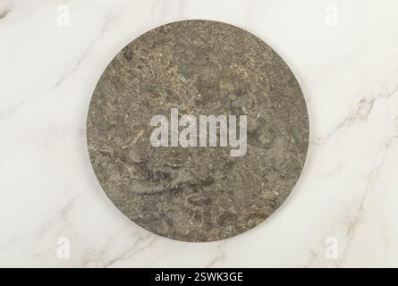 Top view of brown marble tray, plate, bowl and black cutlery on pink ...