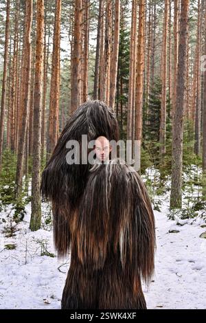 Traditional Kukeri dancers in long fur costumes perform a circle dance ...