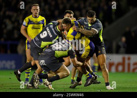 Luke Yates of Warrington Wolves is tackled during the Betfred Super ...