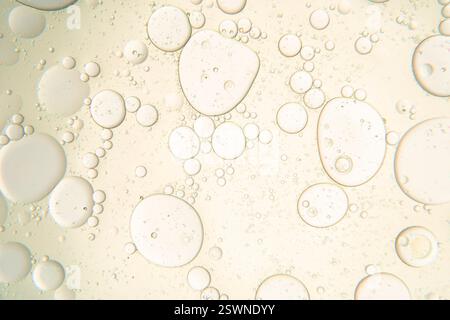 Abstract composition with water, oil drops and blue ink against white ...