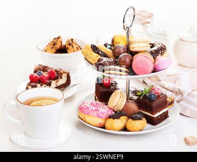 Cake stand with macaroons, mini cakes, cookies for tea Stock Photo - Alamy
