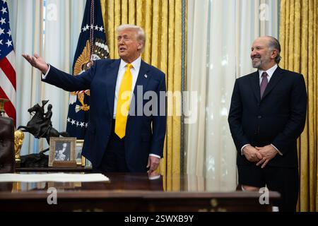 President Donald Trump speaks as Commerce Secretary Howard Lutnick ...
