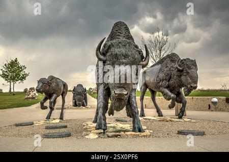 A statue of a bull in the green field with colorful flowers Stock Photo ...