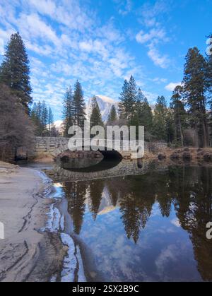 Half dome and a stone bridge reflected in the merced river Stock Photo ...
