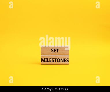 Set milestones symbol. Concept word Set milestones on wooden blocks ...