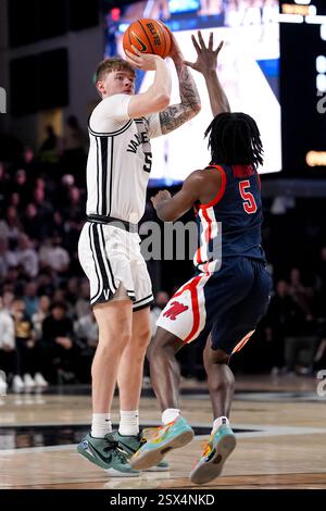 Vanderbilt guard Tyler Nickel shoots a 3-pointer as Missouri guard ...