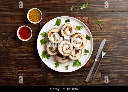 Sliced pork roll with pepper served on rustic wooden board. Fresh ...