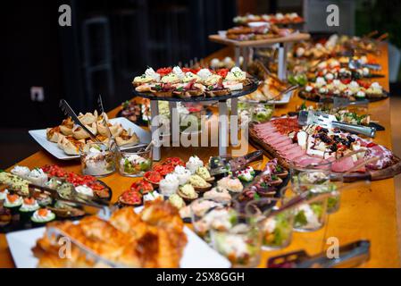 An impressive spread of canapes decorates a long table at a stylish ...