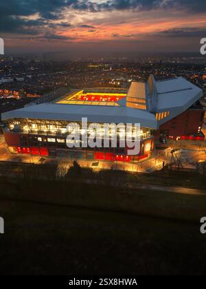 A breathtaking drone shot of Anfield at dusk, with stadium lights ...