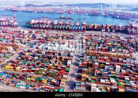 A busy container terminal at Qingdao Port in east China's Shandong ...