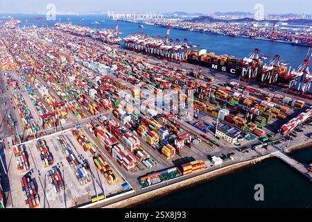 A busy container terminal at Qingdao Port in east China's Shandong ...