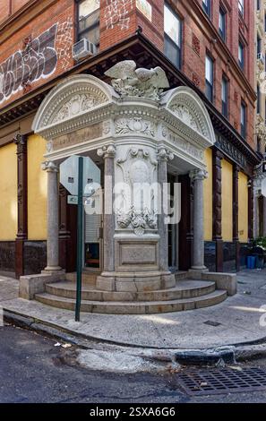 An elaborate cast iron storefront inset with stone and terra cotta at ...