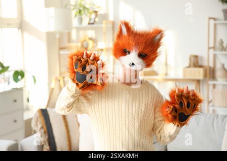 Quadrober girl in cat disguise playing at home Stock Photo - Alamy