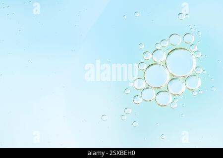 Transparent water bubbles rising in a light blue liquid background ...