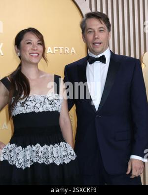 Samantha Quan, left, and Sean Baker accept the award for best picture for "Anora" during the ...