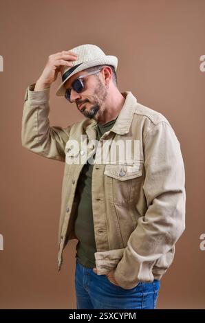 Studio shot of man against brown background Stock Photo - Alamy