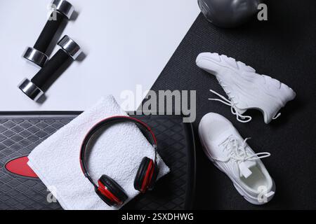 Different gym stuff and headphones on grey background, flat lay. Space ...