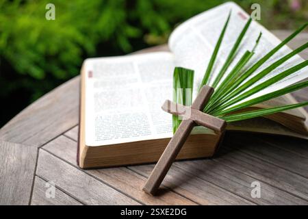 Holy Bible, cross and palm leaf on wooden background Stock Photo - Alamy