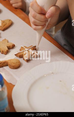 Decorating gingerbread cookies with royal icing for Christmas Stock ...
