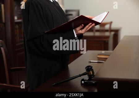 Judge with folder of documents in courtroom Stock Photo - Alamy
