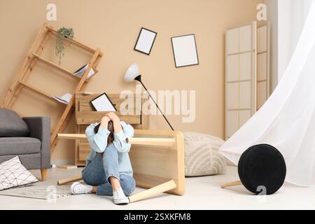Woman sitting near overturned table during earthquake at home Stock ...