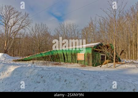 Old green barn collapses due to age and heavy snow load in winter Stock ...