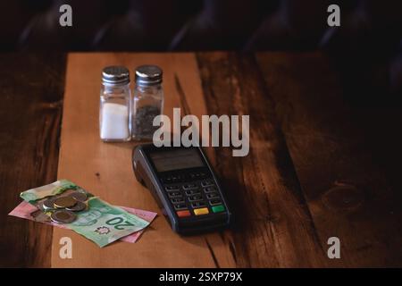 Canadian cash money and payment terminal on restaurant table Stock ...