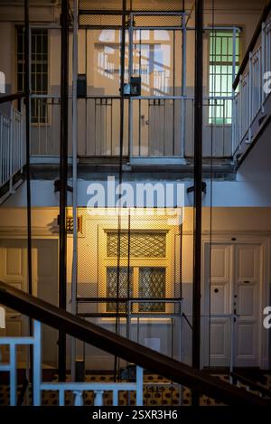 Interior staircase shaft and elevator cables in an old apartment ...