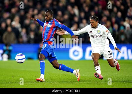 Crystal Palace's Tyrick Mitchell (left) attempts a headed shot towards ...